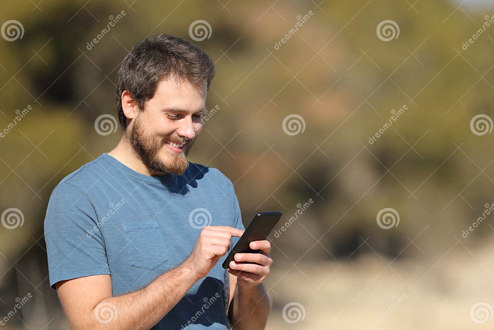 Happy Man Checking Cellphone in Nature Stock Photo - Image of busy ...