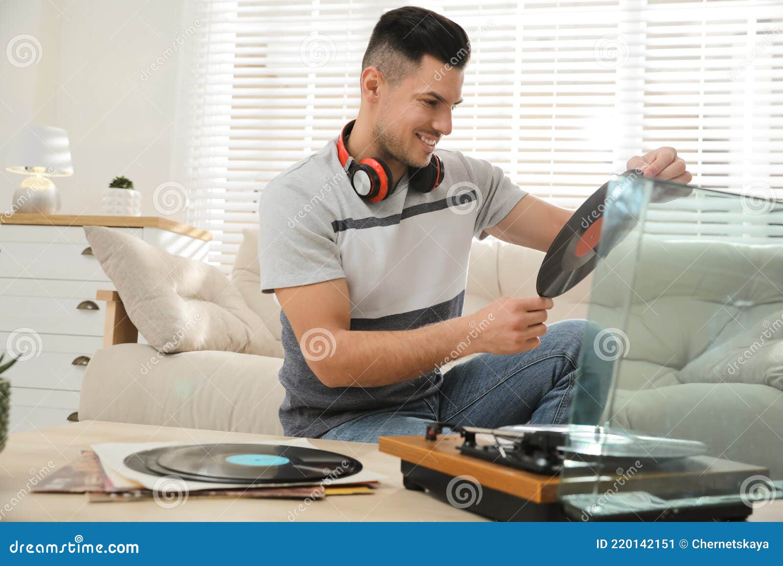 Happy Man Choosing Vinyl Record To Play with Turntable at Home Stock ...