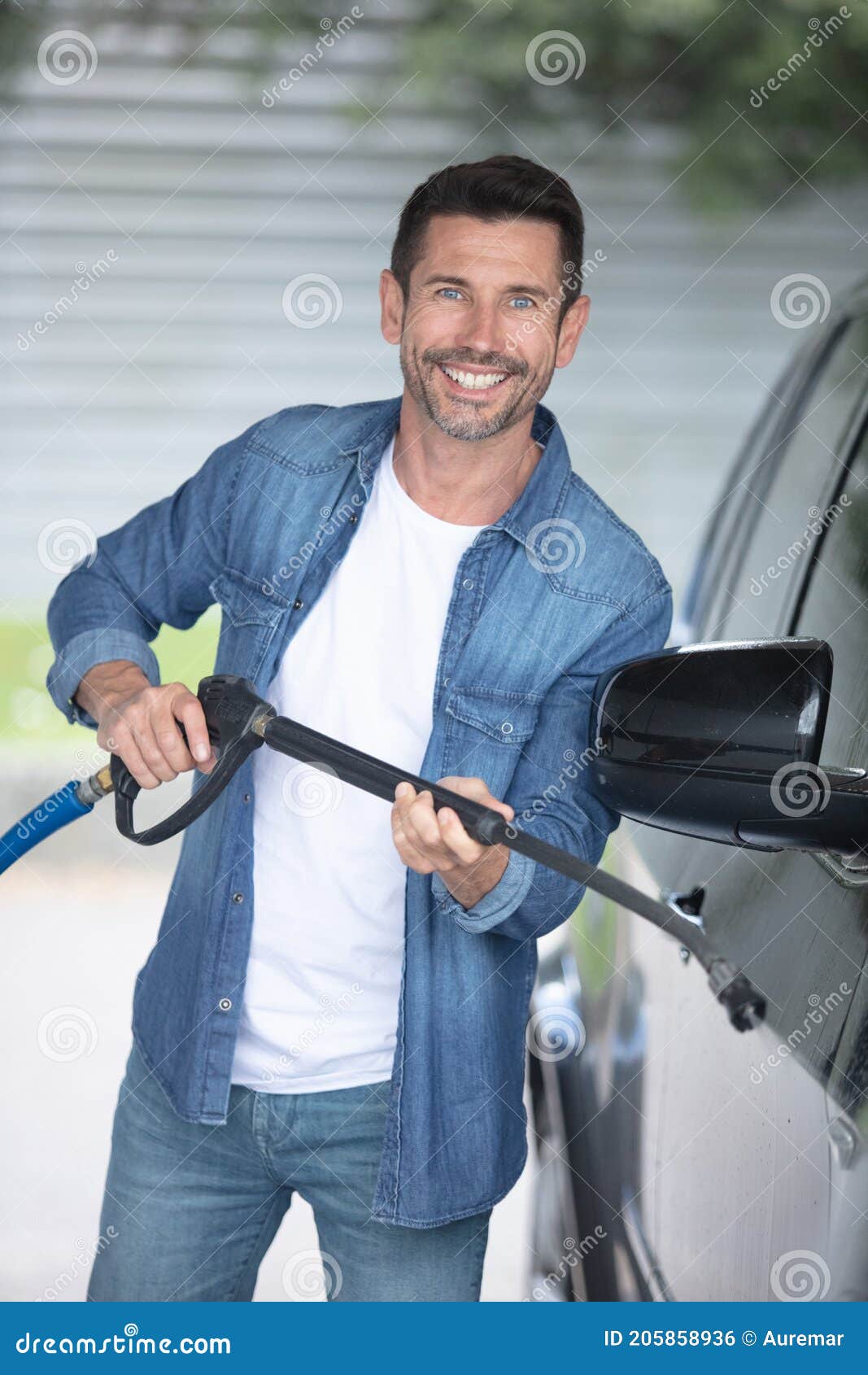 Happy man cleaning car stock photo. Image of people - 205858936