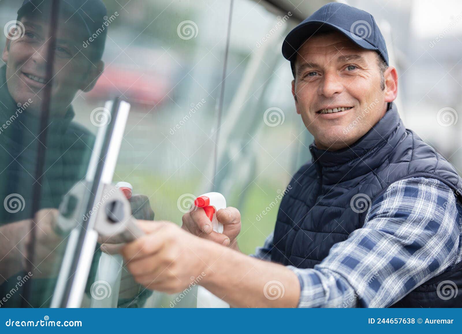 Happy man cleaning windows stock photo. Image of lifestyle - 244657638