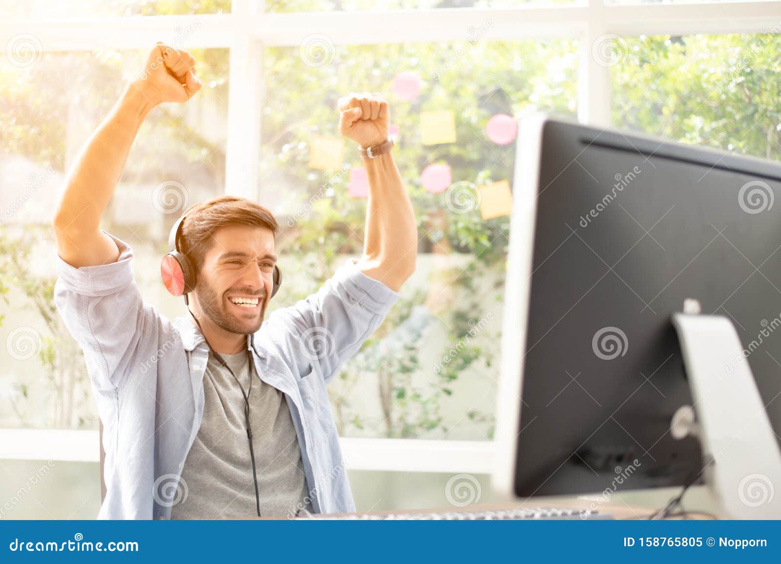 Happy Man Completed Task And Triumphing With Raised Hands And Screaming