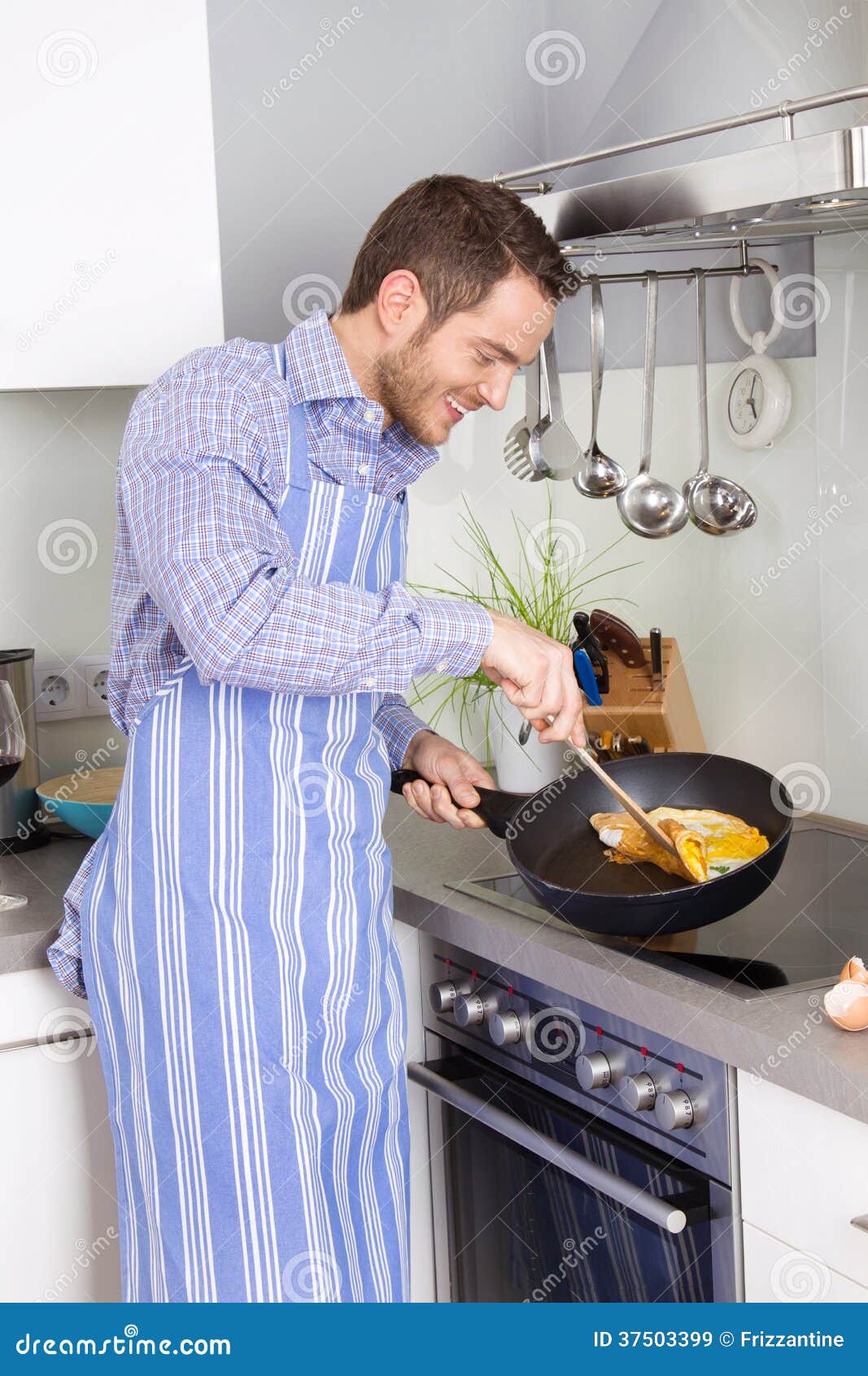 Happy Man Cooking Egg Omelet in the Kitchen. Stock Image - Image of ...