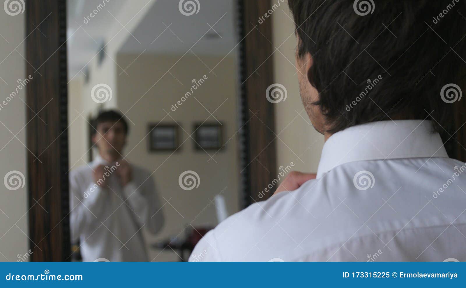 Young Man Dressing Himself in Front of Mirror. Stock Image - Image of ...