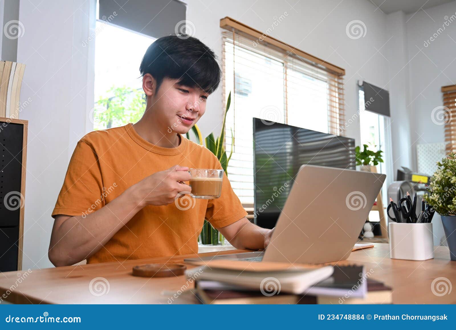 Man Drinking Coffee and Using Laptop Computer at Home in the Morning ...