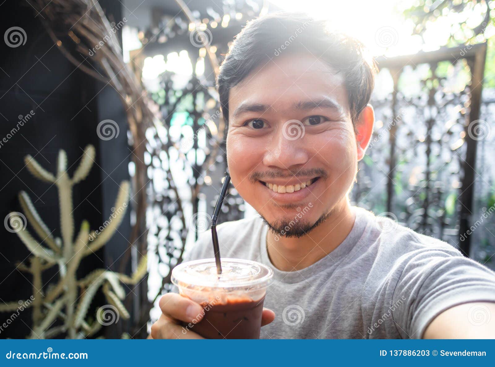 Happy Man Drinking Ice Chocolate in the Plastic Glass Stock Image ...