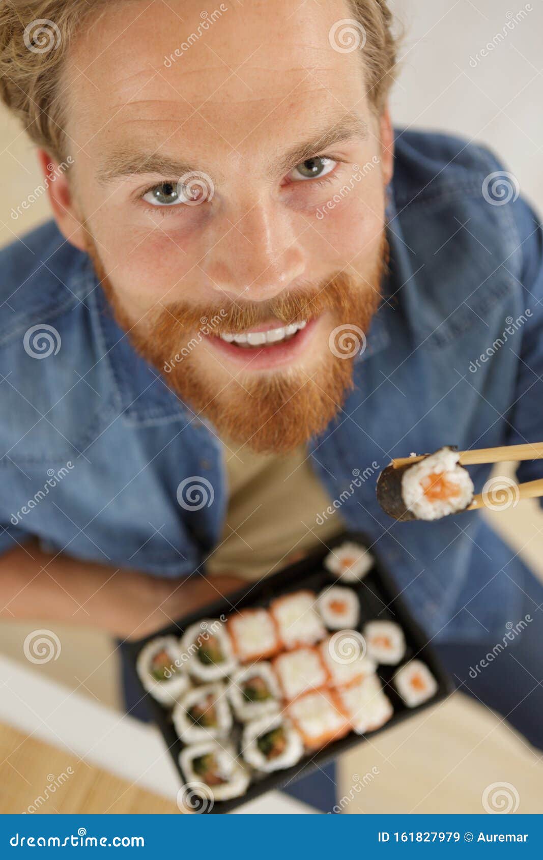 Happy man eating sushi stock image. Image of salmon - 161827979