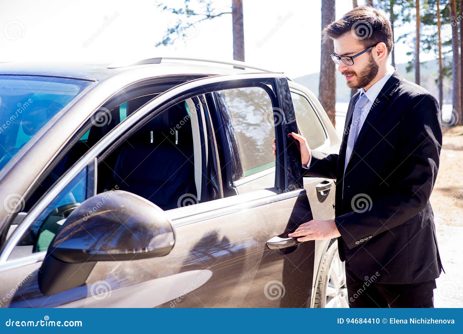 Happy man entering his car stock photo. Image of owner - 94684410
