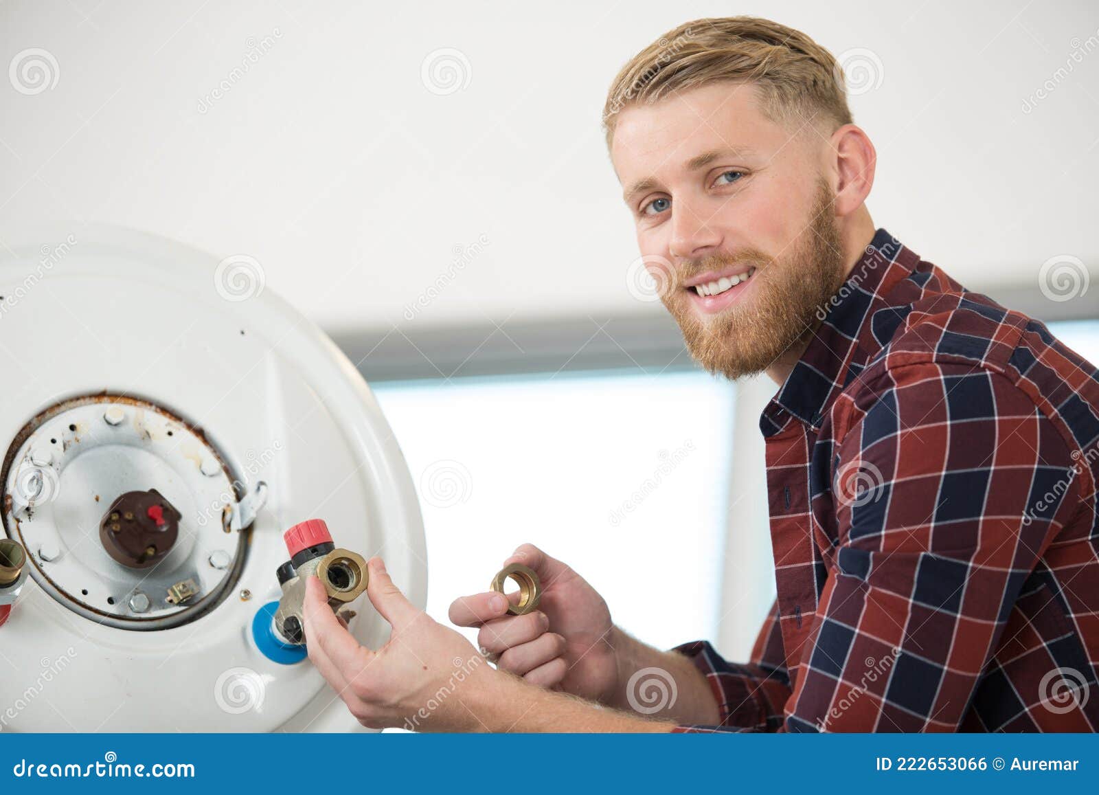Happy man fixing boiler stock photo. Image of upkeep - 222653066