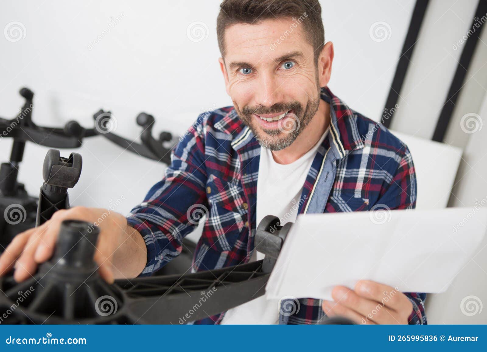 Happy man fixing chair stock photo. Image of computer - 265995836
