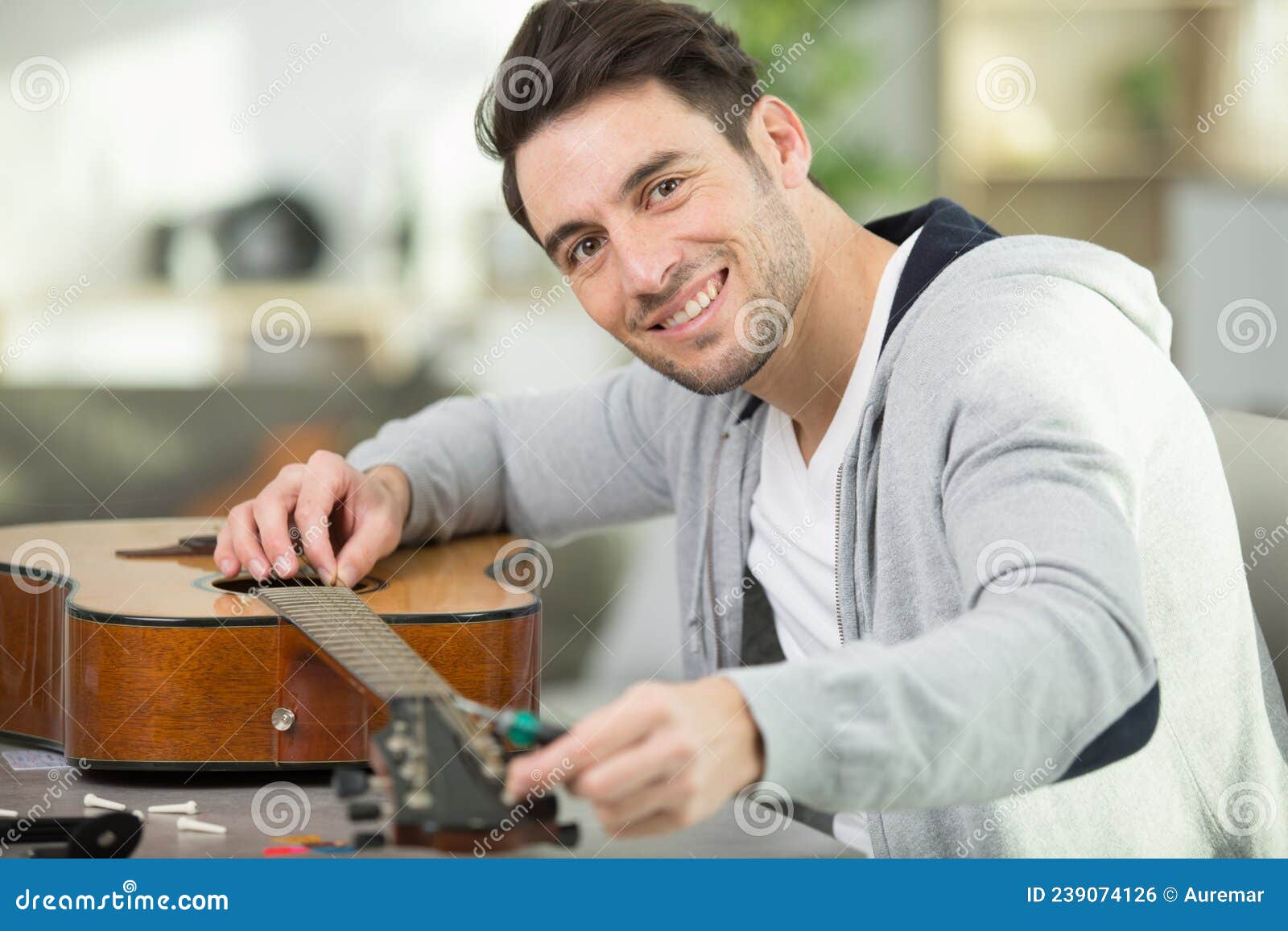 Happy man fixing guitar stock photo. Image of shop, repairman - 239074126