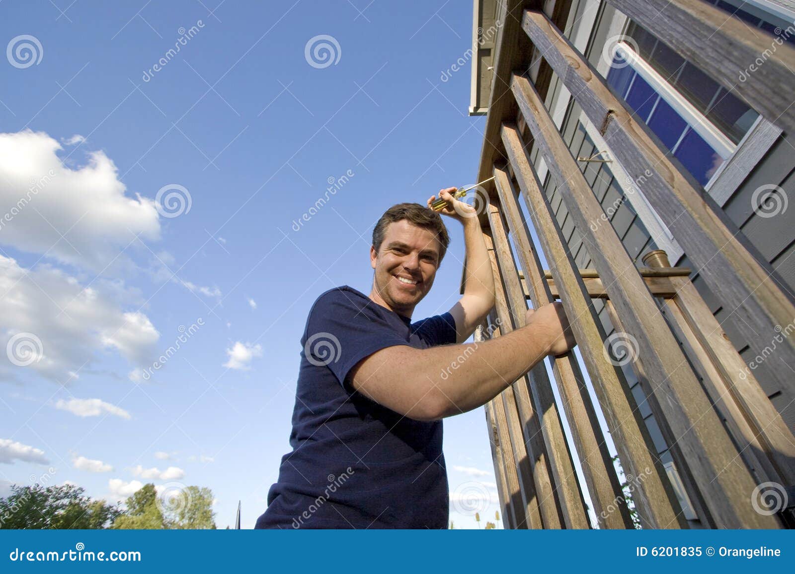 Happy Man Fixing House - Horizontal Stock Image - Image of outside ...