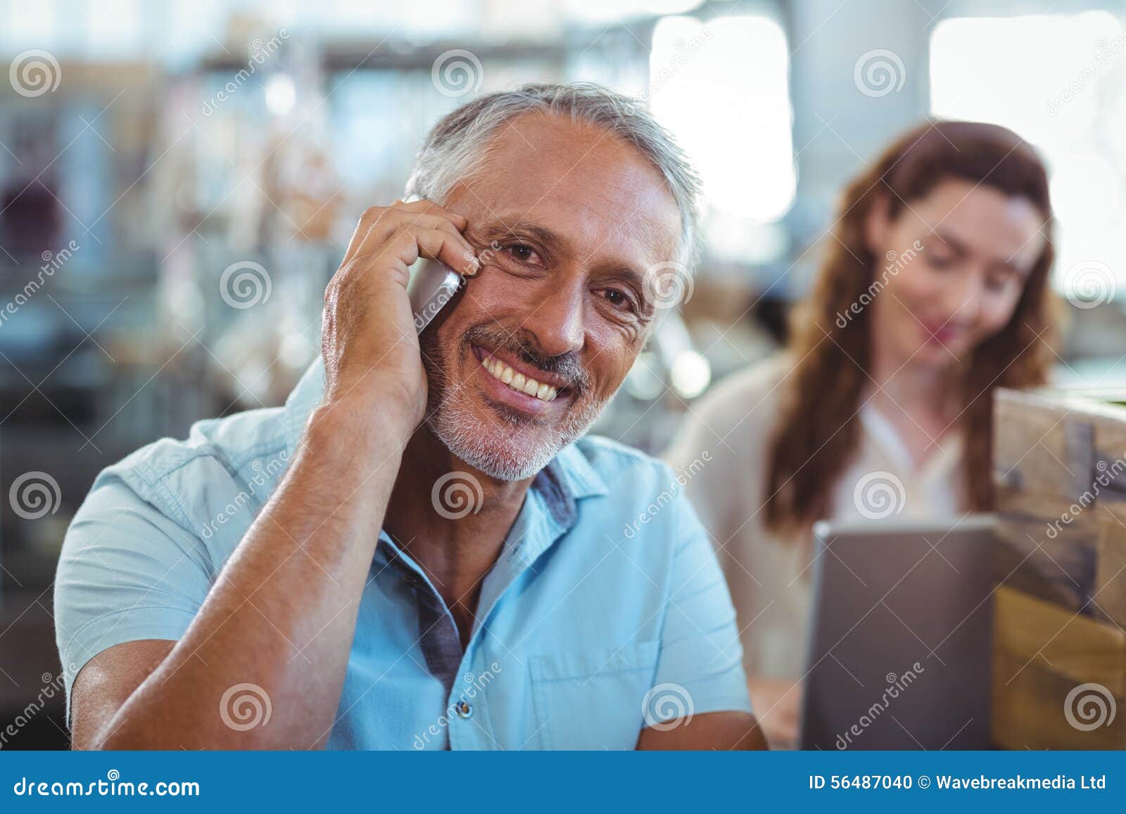 Happy Man Having Phone Call and Smiling at Camera Stock Photo - Image ...