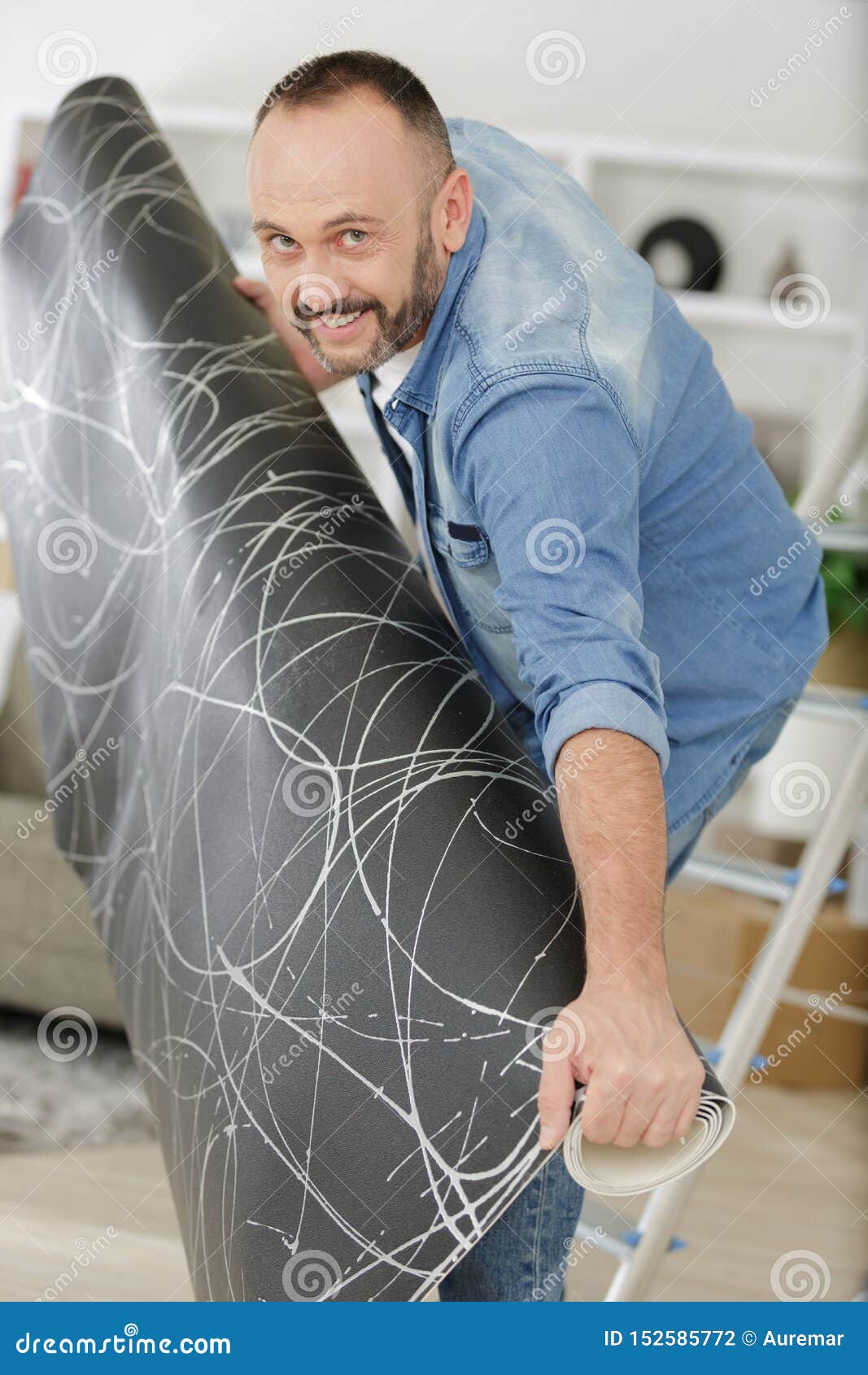 Happy man holding carpet stock photo. Image of husband - 152585772