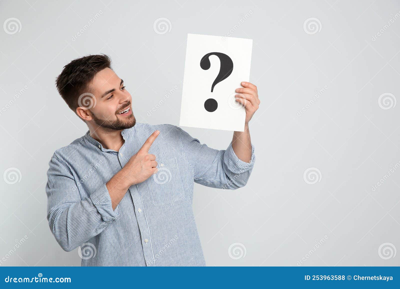 Happy Man Holding Question Mark Sign on Background Stock Photo - Image ...