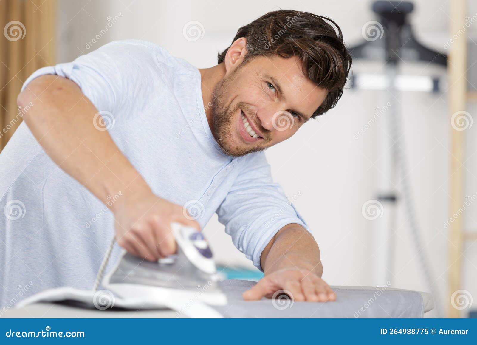 Happy man ironing clothes stock image. Image of holding - 264988775