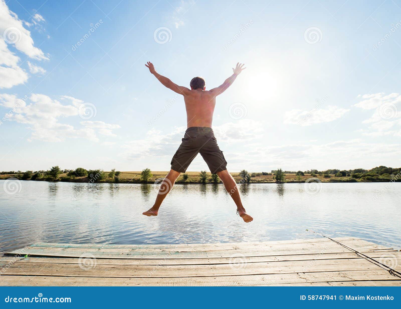 Happy man jumping on pier stock image. Image of healthy - 58747941