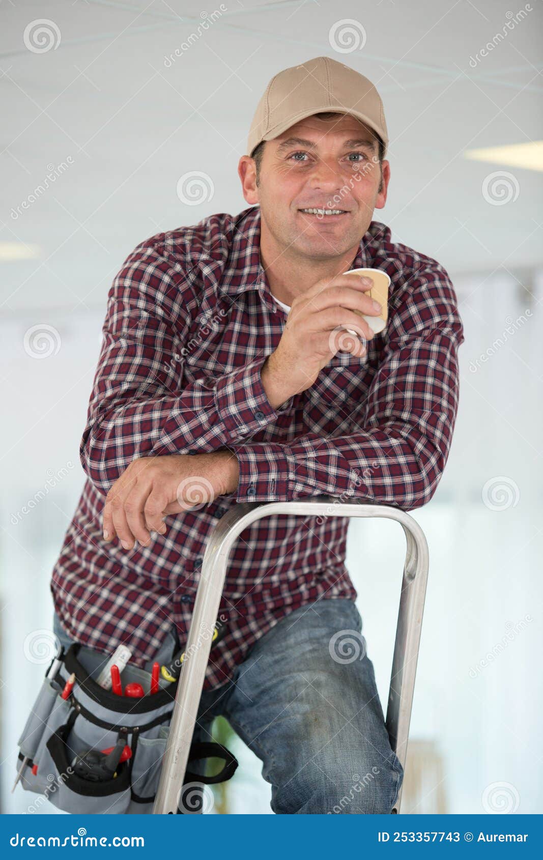 Happy man with on ladder stock image. Image of professional - 253357743