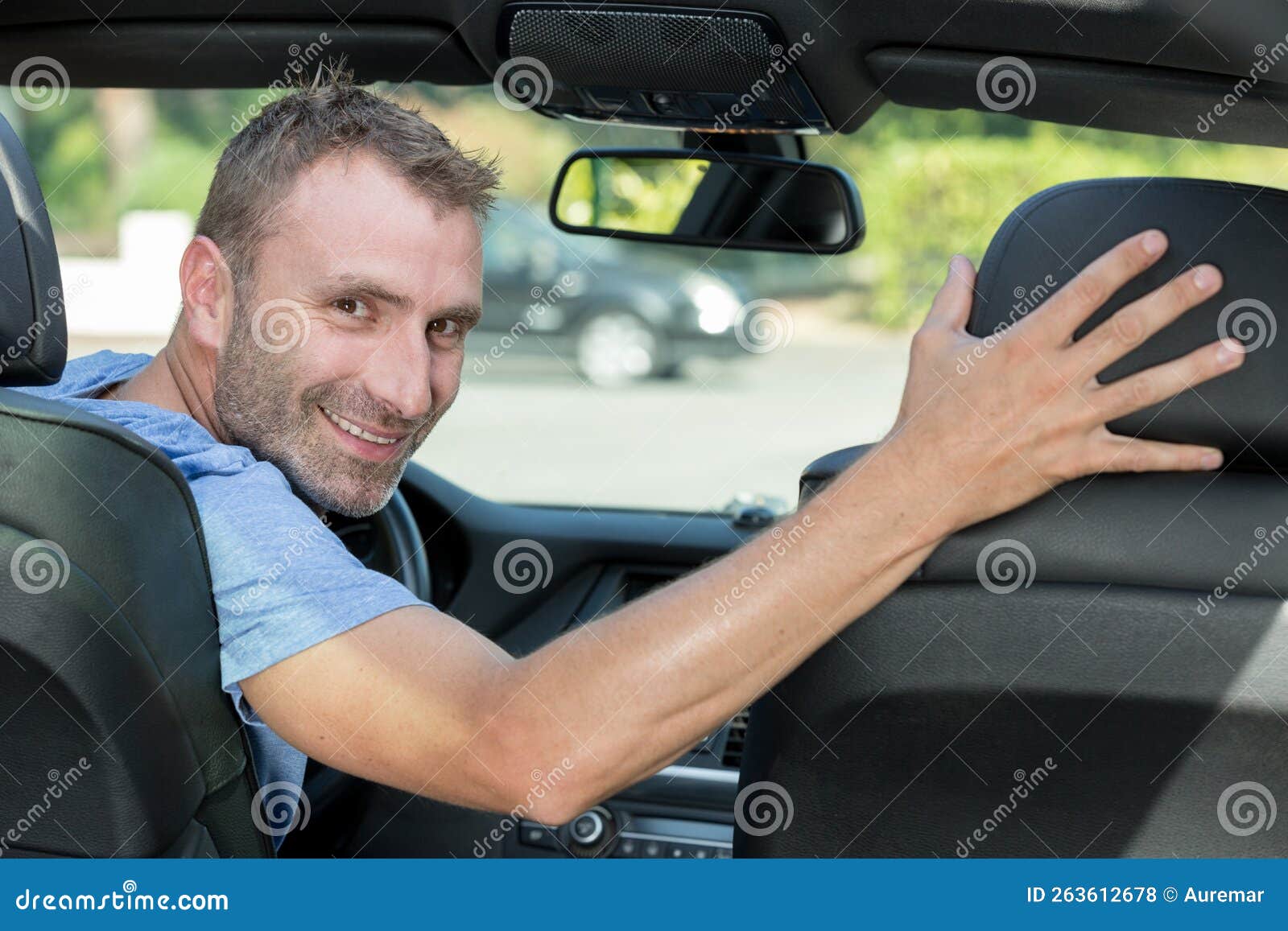 Happy Man Looking Over Shoulder Stock Photo - Image of windscreen ...