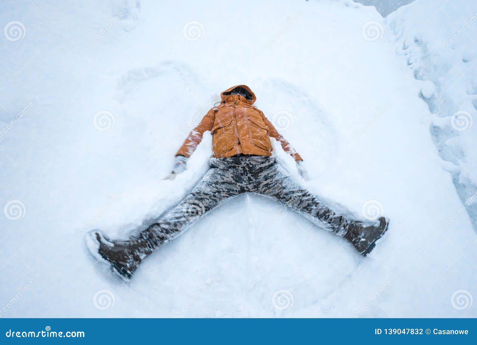 Happy Man Lying Down on the Snow in Winter Stock Photo - Image of snowy ...