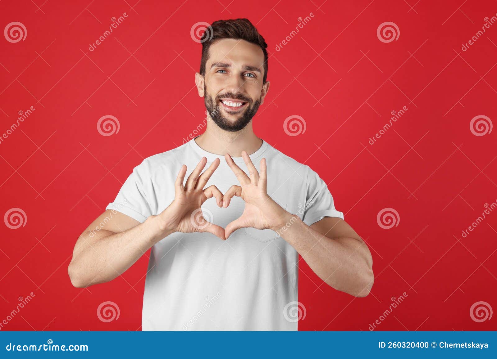 Happy Man Making Heart with Hands on Red Background Stock Photo - Image ...