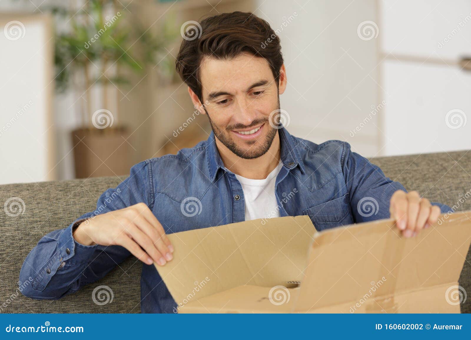 Happy Man Opening Parcel Box at Home Stock Photo - Image of consumer ...