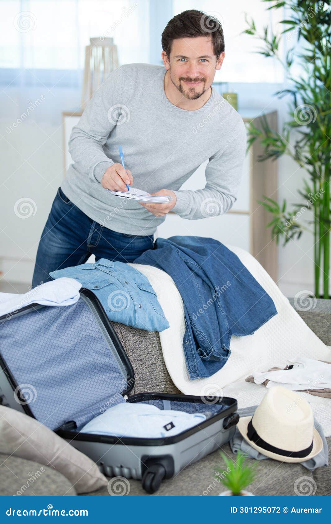 Happy man packing luggage stock photo. Image of business - 301295072