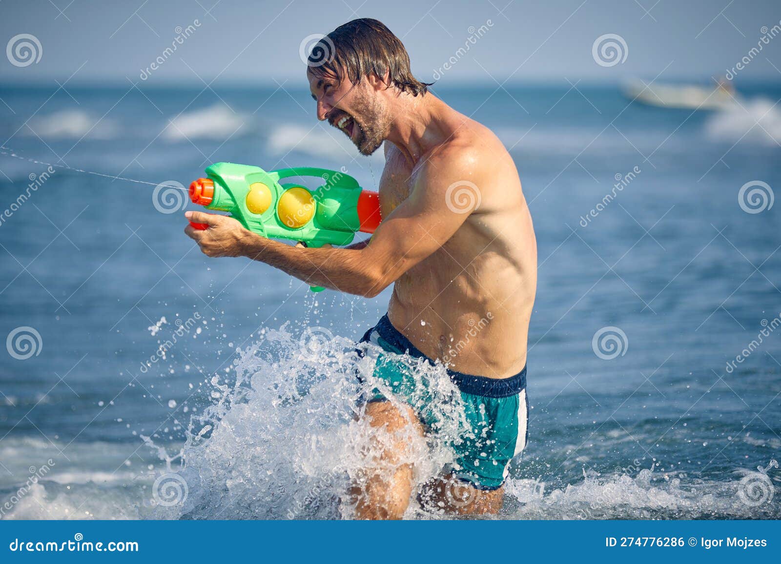 Man Playing with Water Gun on the Beach Stock Photo - Image of nature ...