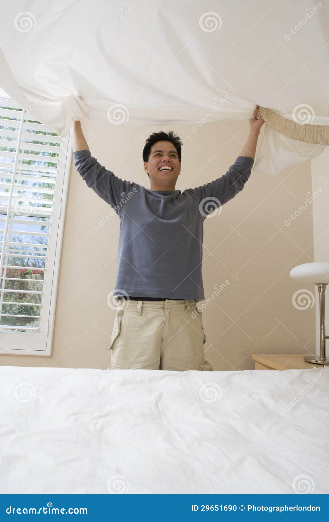 Happy Man Preparing Bed at Home Stock Photo - Image of arrangement ...