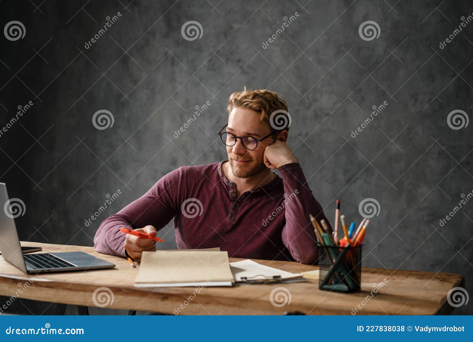 The Happy Man Propping His Head with the Hand while Sitting in the ...