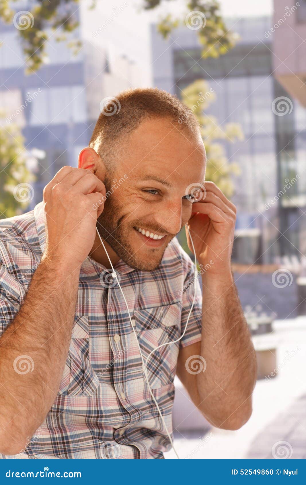 Happy Man Putting in Earbuds Stock Photo - Image of joyous, listen ...