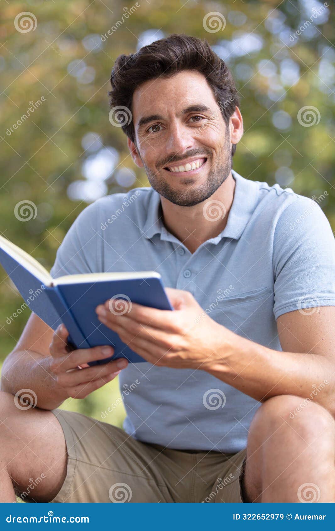 Happy Man Reading Book Outside in Park Stock Image - Image of holding ...
