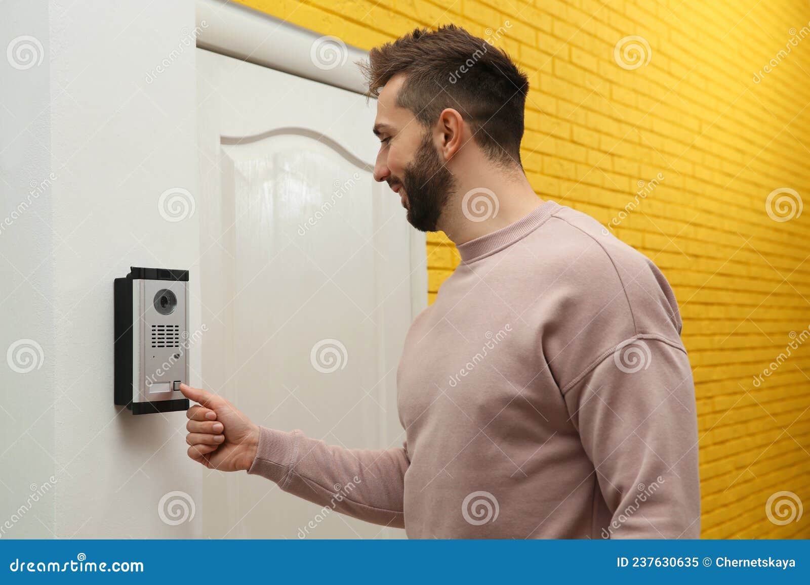 Happy Man Ringing Intercom with Camera in Entryway Stock Image - Image ...