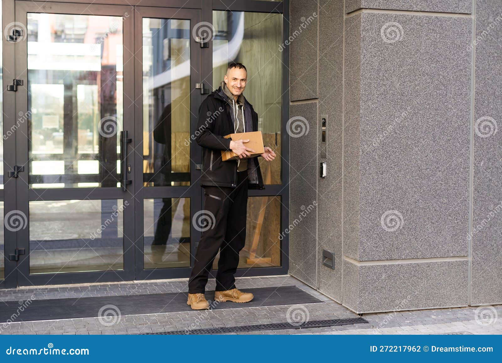 Happy Man Ringing Intercom with Camera in Entryway. Stock Photo - Image ...
