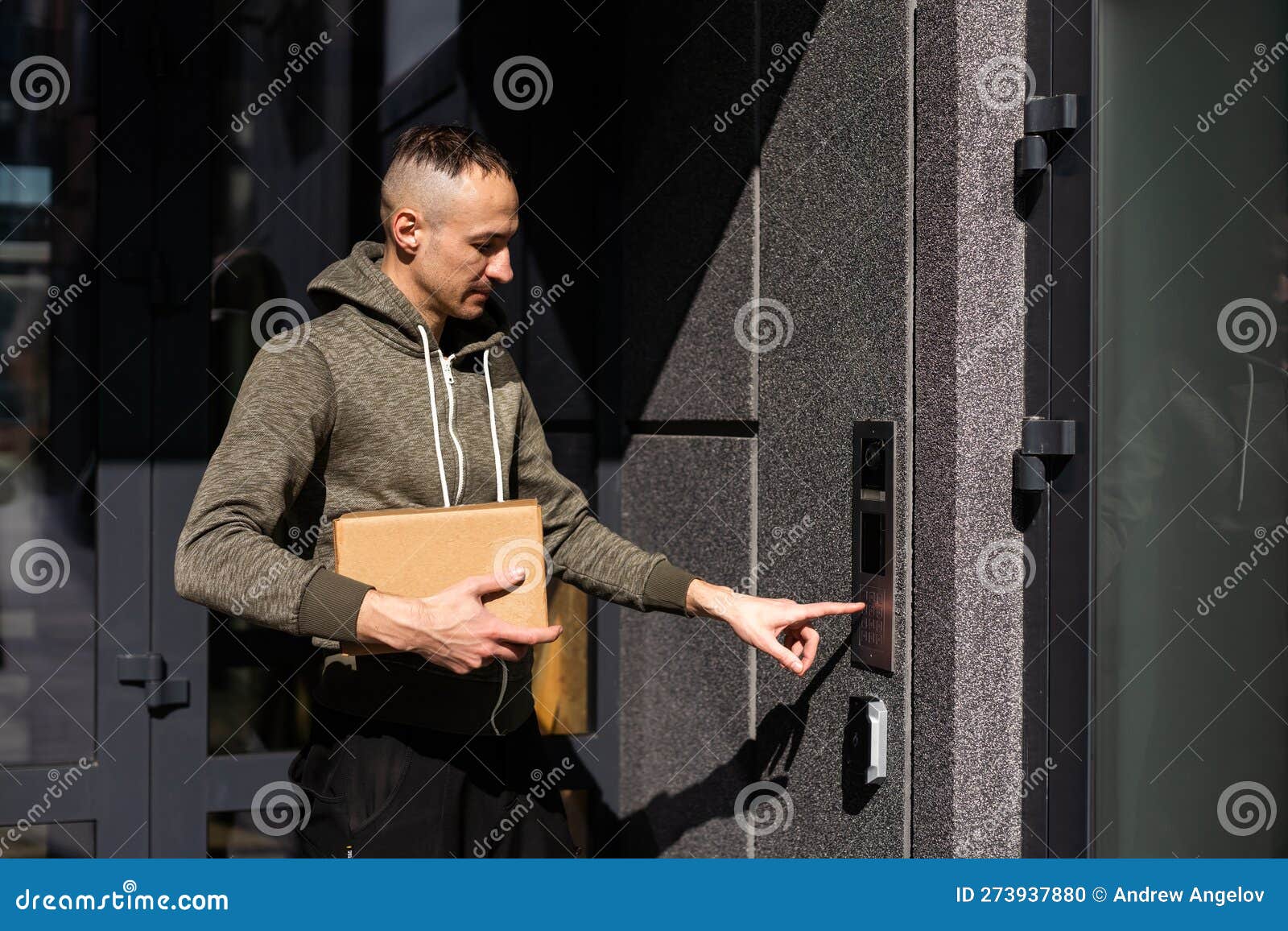 Happy Man Ringing Intercom with Camera in Entryway. Stock Photo - Image ...