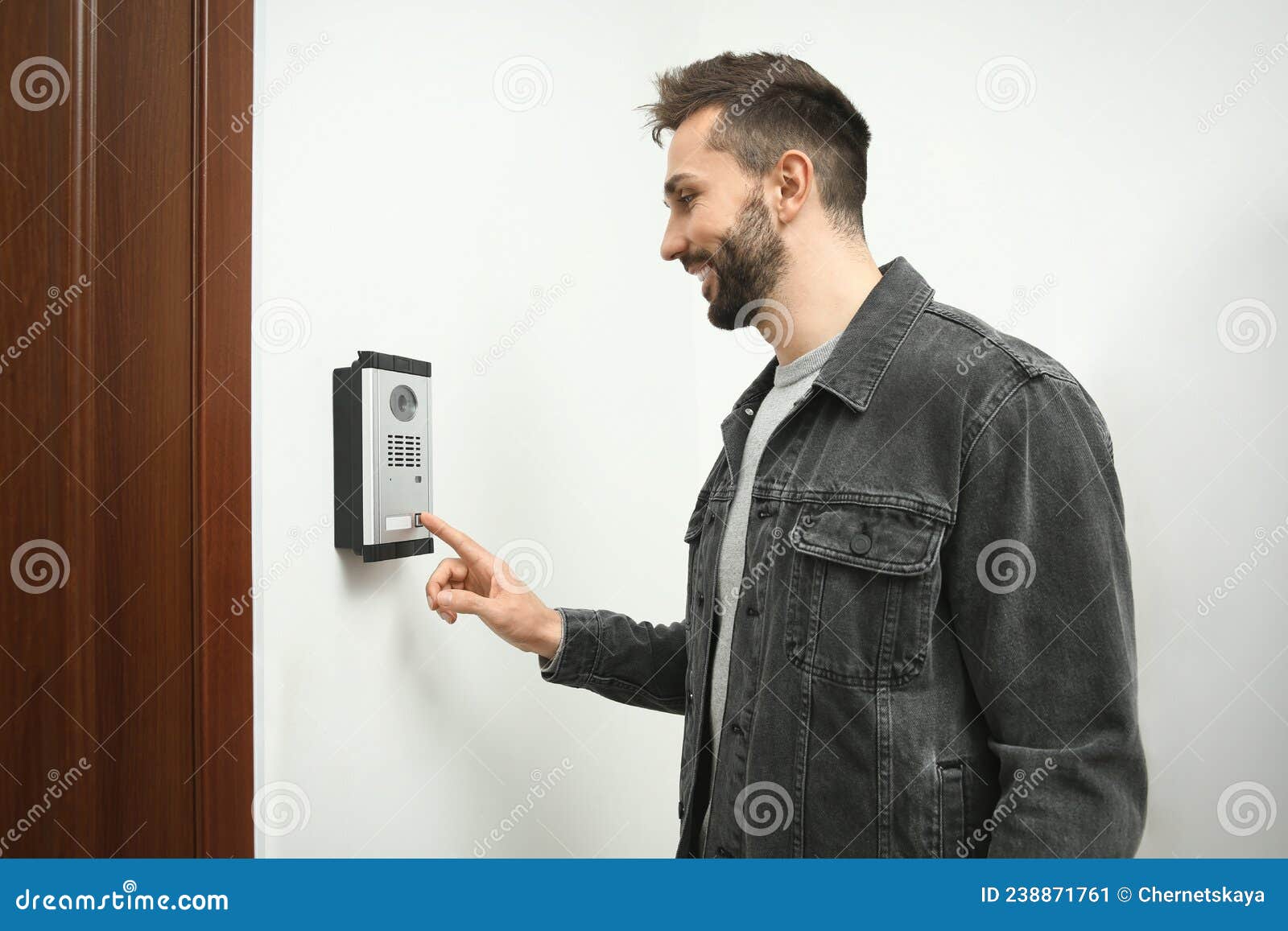 Happy Man Ringing Intercom with Camera in Entryway Stock Image - Image ...