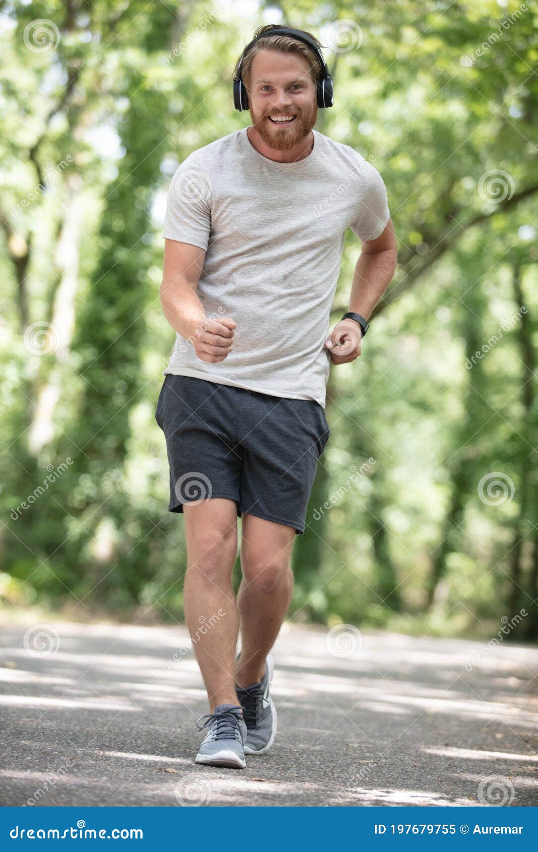 Happy man running outdoors stock image. Image of jogging - 197679755