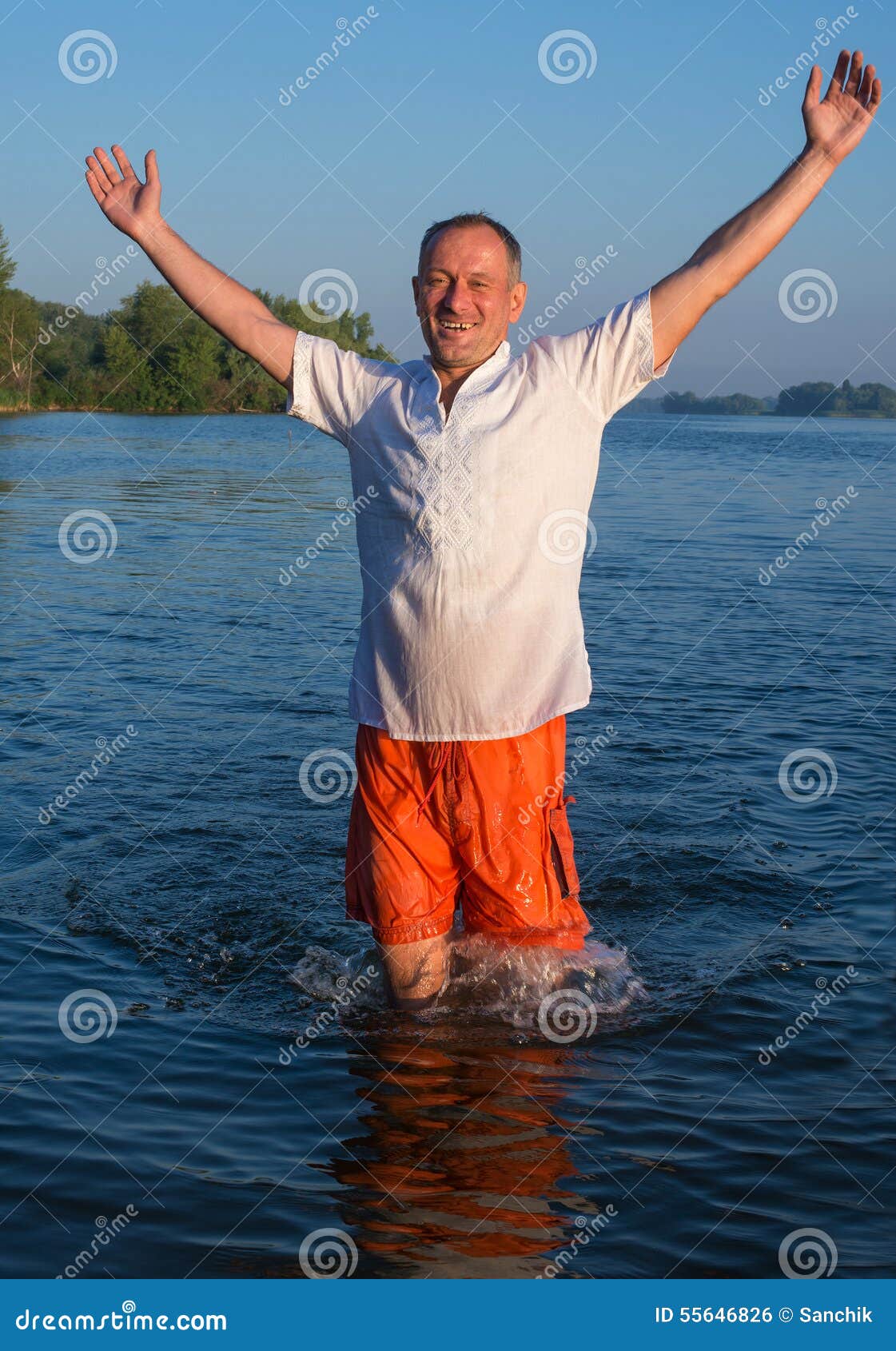 Happy man running in water stock photo. Image of cheers - 55646826