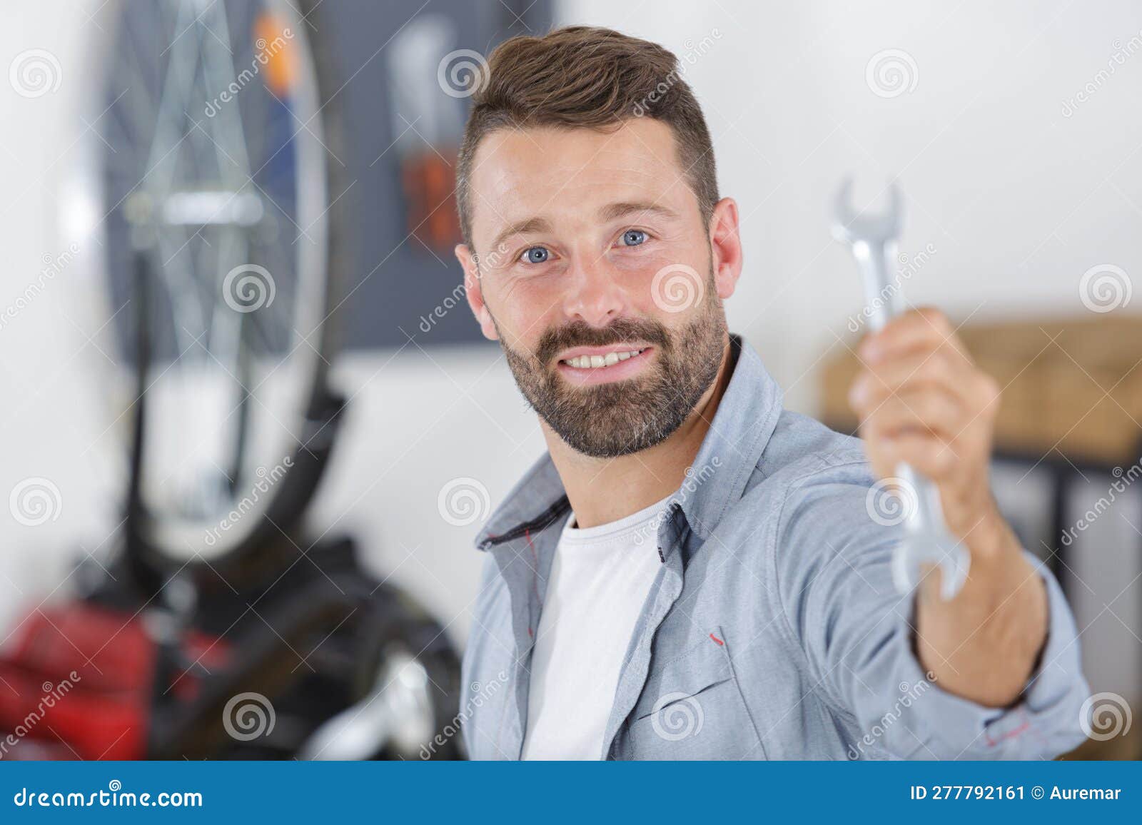 Happy man showing spanner stock image. Image of house - 277792161
