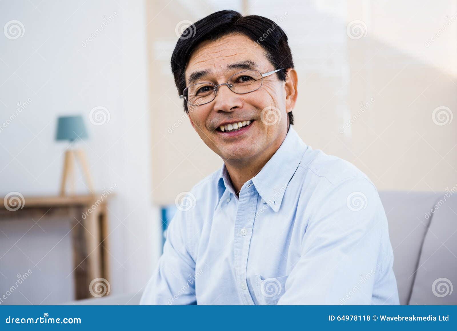 Happy man sitting at home stock photo. Image of apartment - 64978118