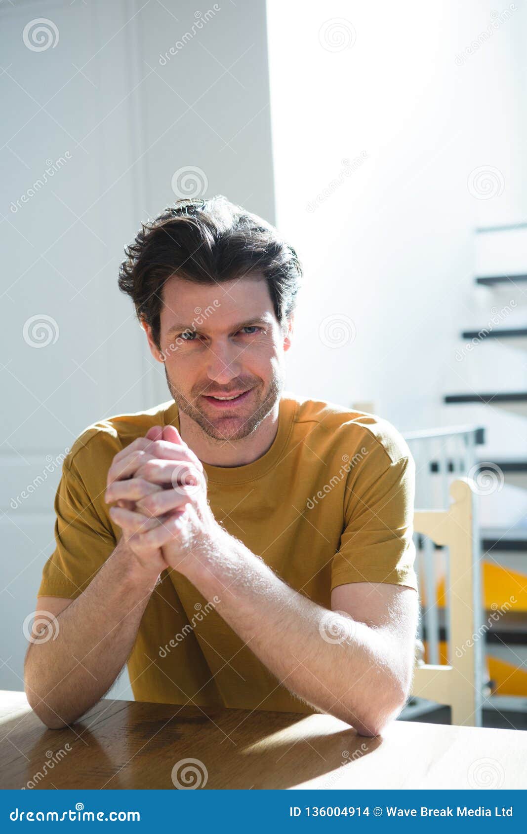 Happy man sitting at home stock photo. Image of looking - 136004914