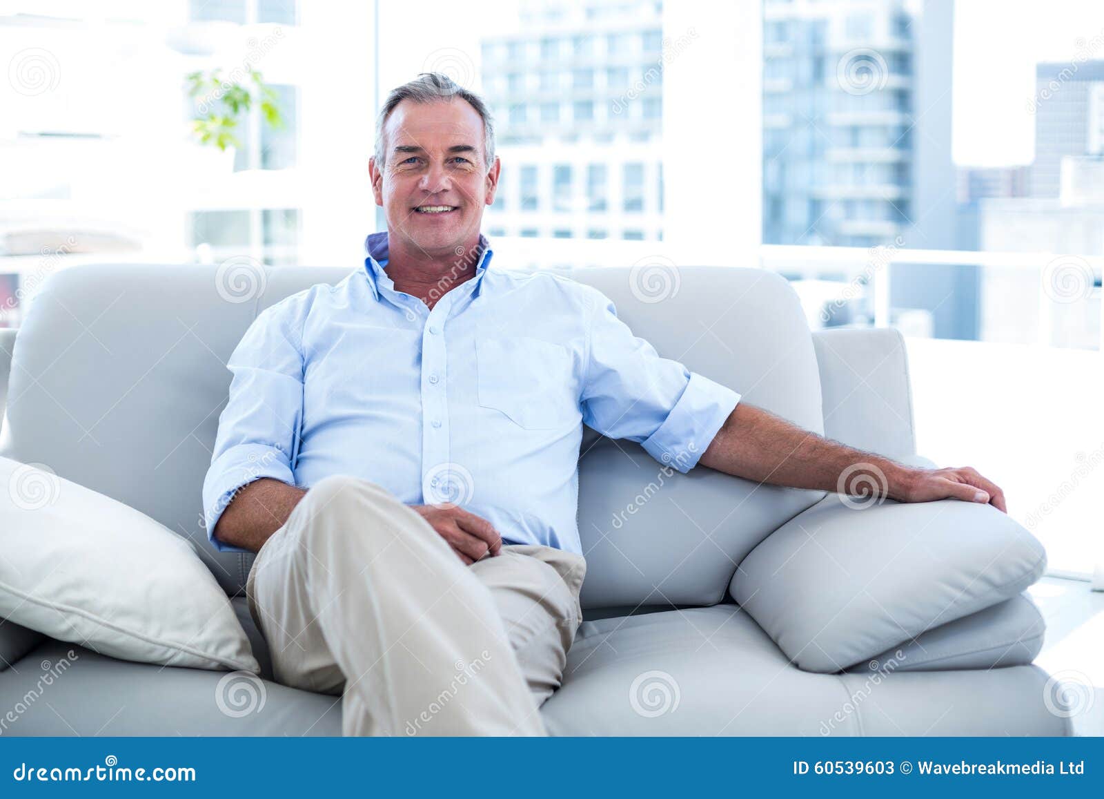 Happy man sitting at home stock image. Image of comfortable - 60539603