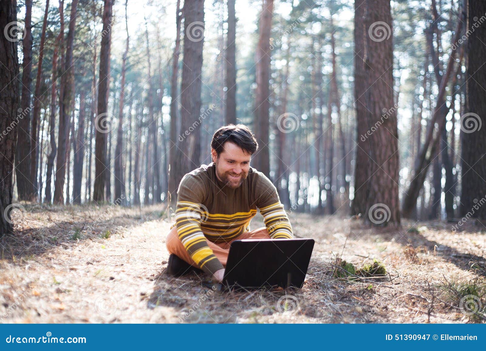 Happy Man Sitting Outdoors Using a Laptop Computer Stock Image - Image ...