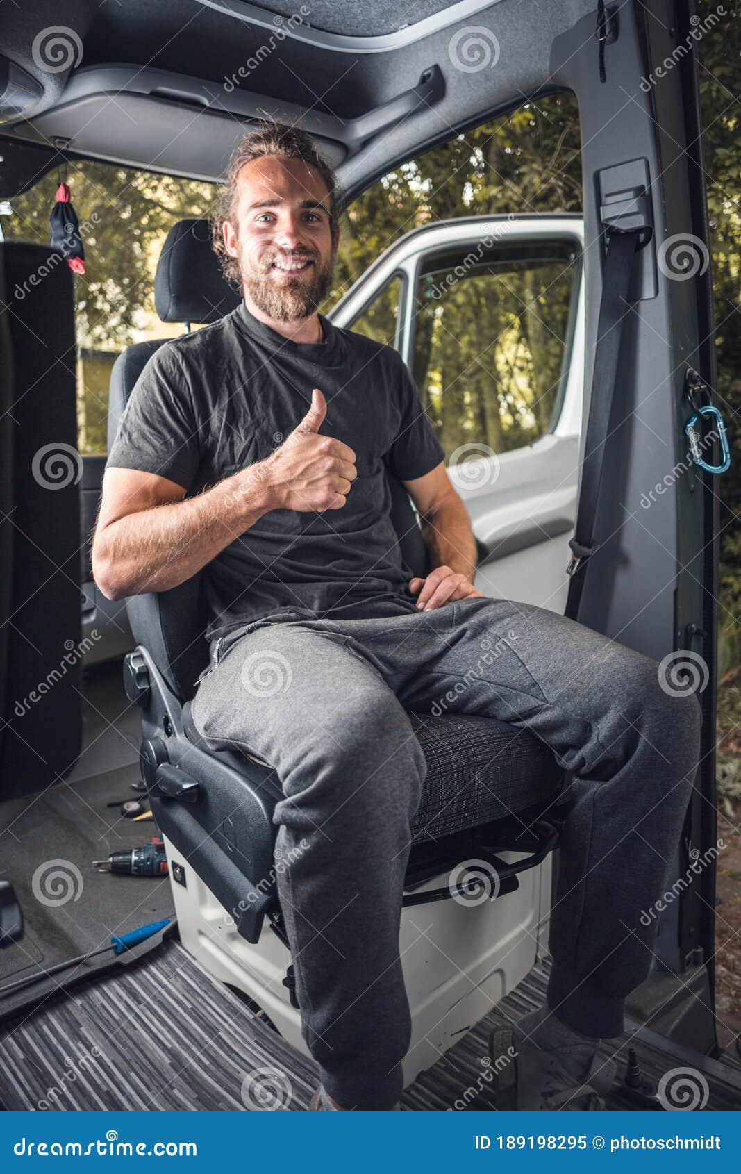Happy Man Sitting in a Swivel Seat Inside His Van Stock Image - Image ...