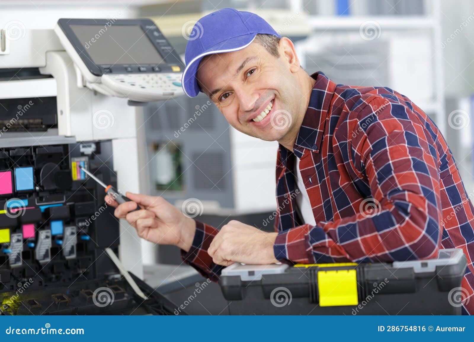 Happy Man Smiling at Camera while Fixing Printer Stock Photo - Image of ...