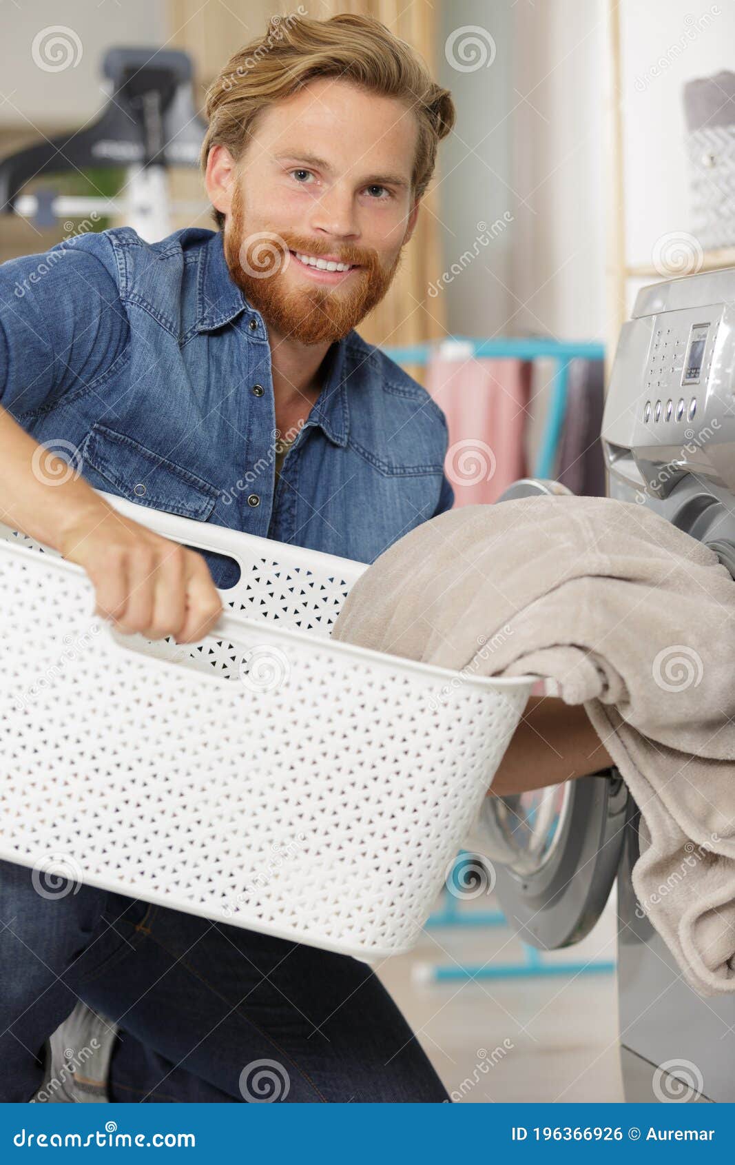 Happy Man Taking Clothes from Drying Machine Stock Photo - Image of ...