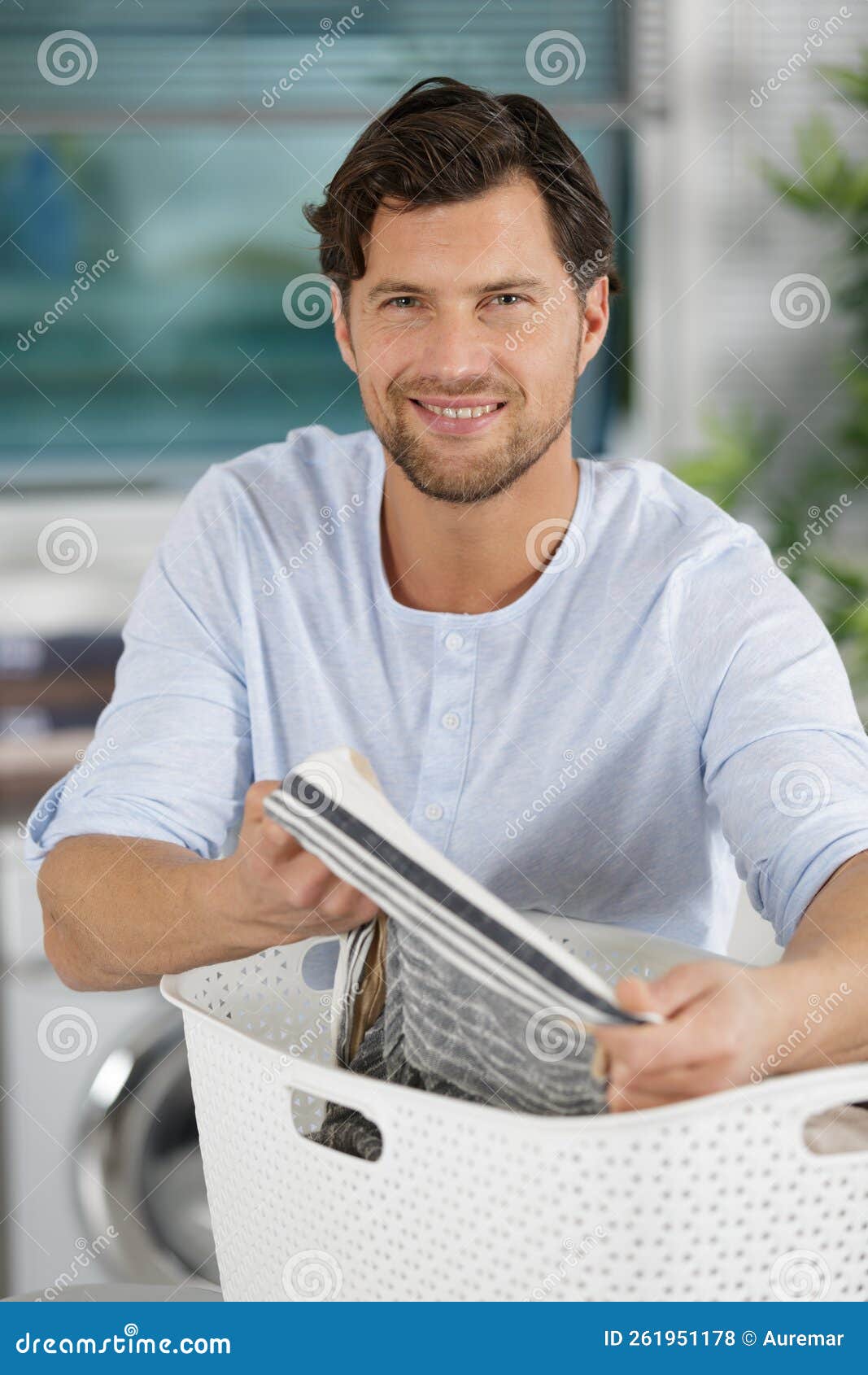 Happy Man Taking Clothes from Drying Rack Stock Photo - Image of adult ...