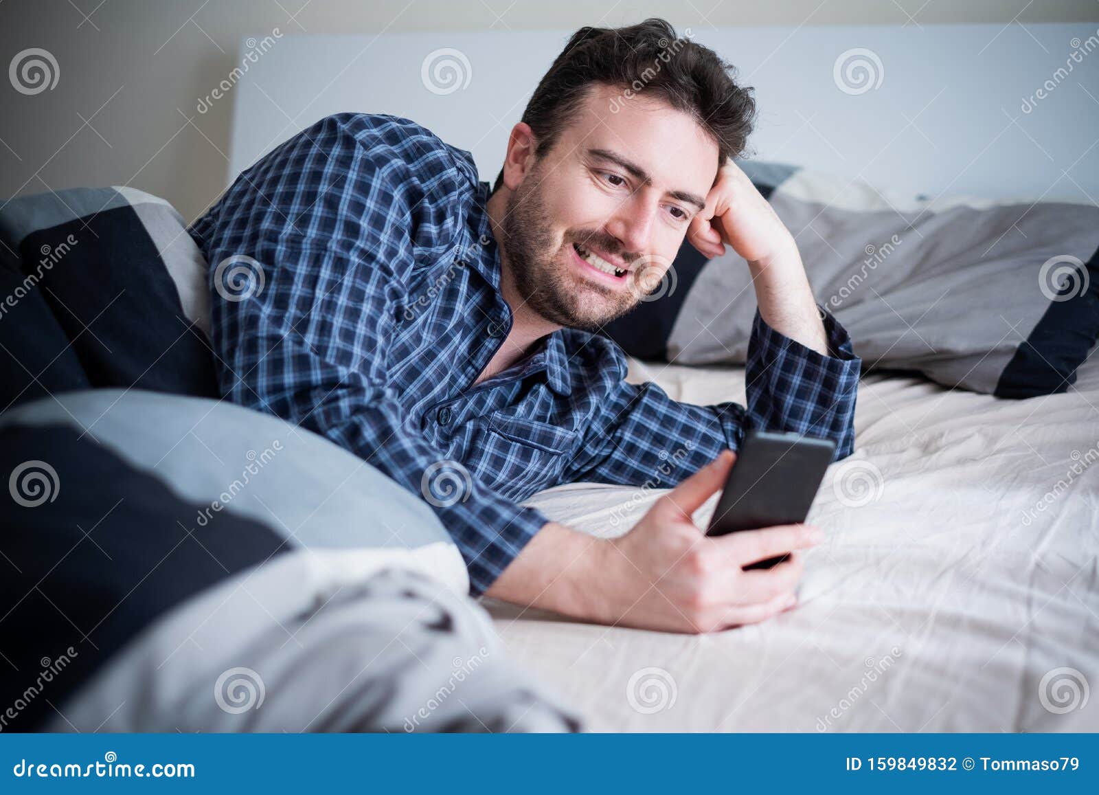 Happy Man Texting on Mobile Phone in Bed Stock Photo - Image of sleep ...