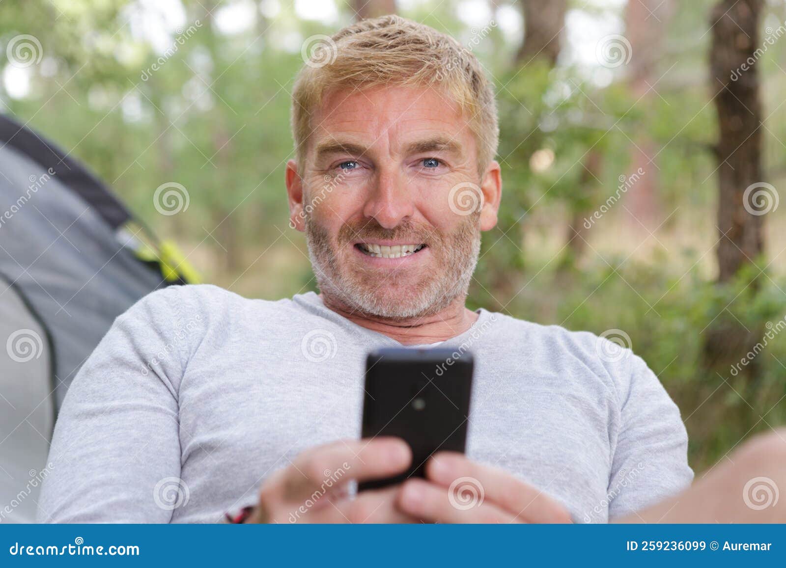 Happy Man Tourist Using Cell Phone in Forest Stock Image - Image of ...