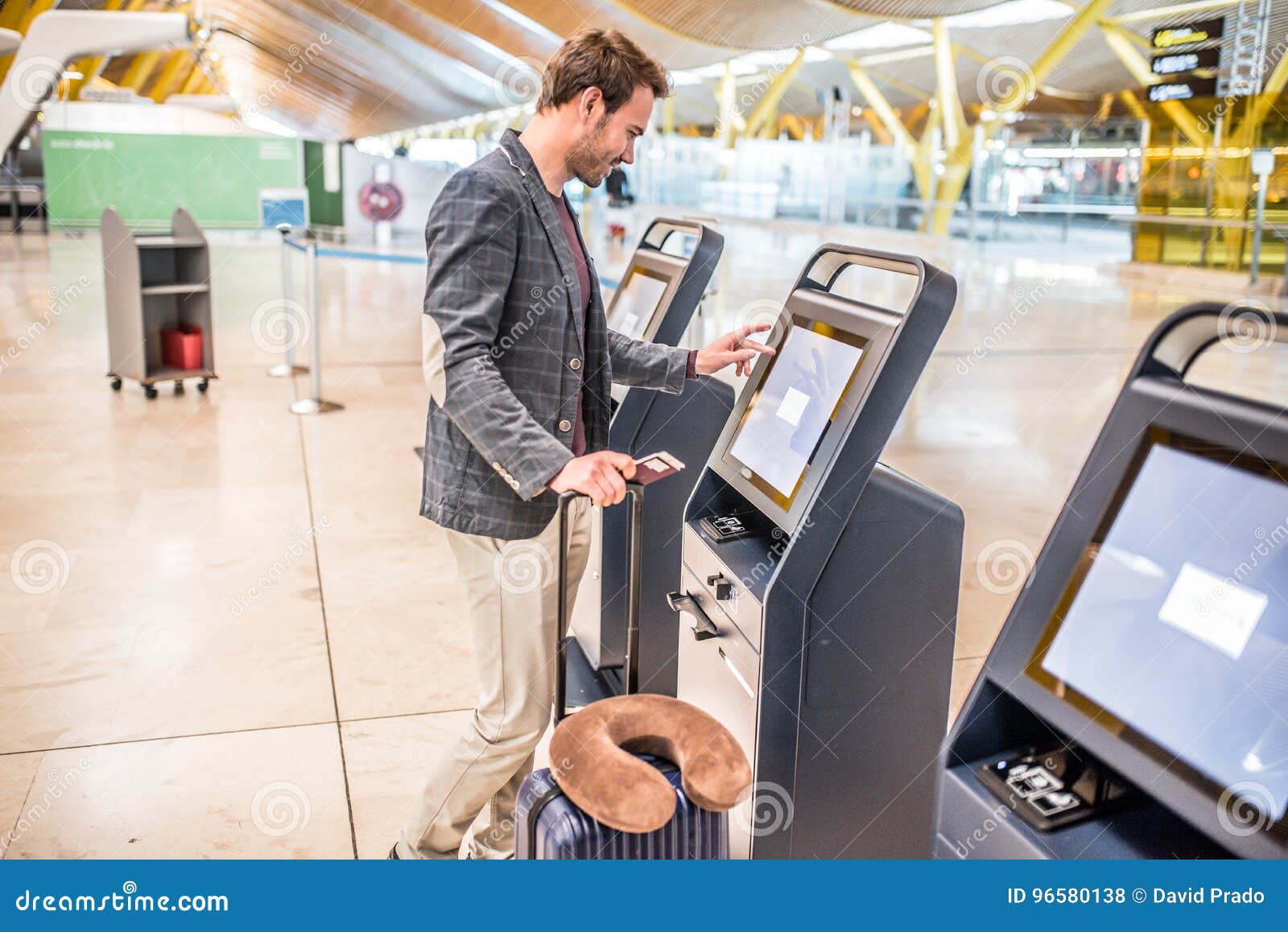 Happy Man Using the Check-in Machine at the Airport Getting the Stock ...