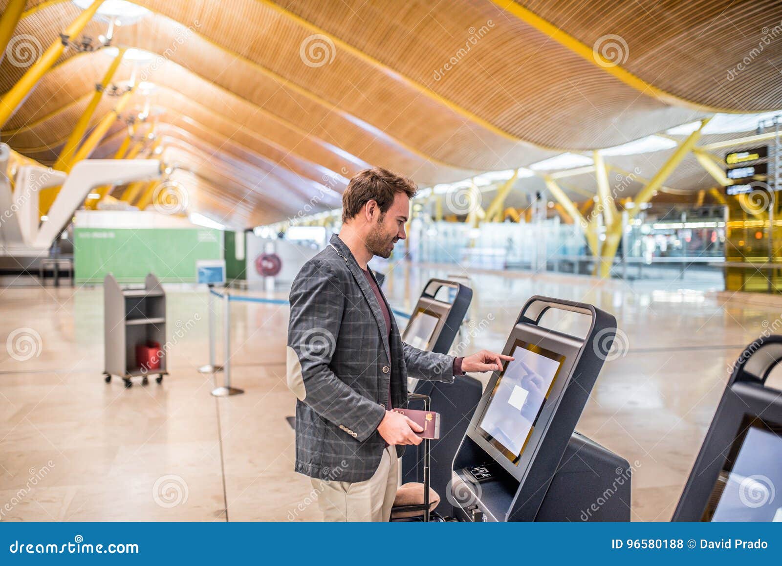 Happy Man Using the Check-in Machine at the Airport Getting the Stock ...